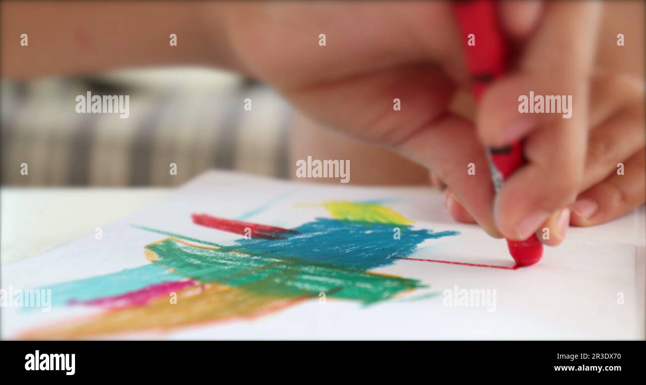 Kid hand drawing with red crayon pen color on paper. Child draws ...