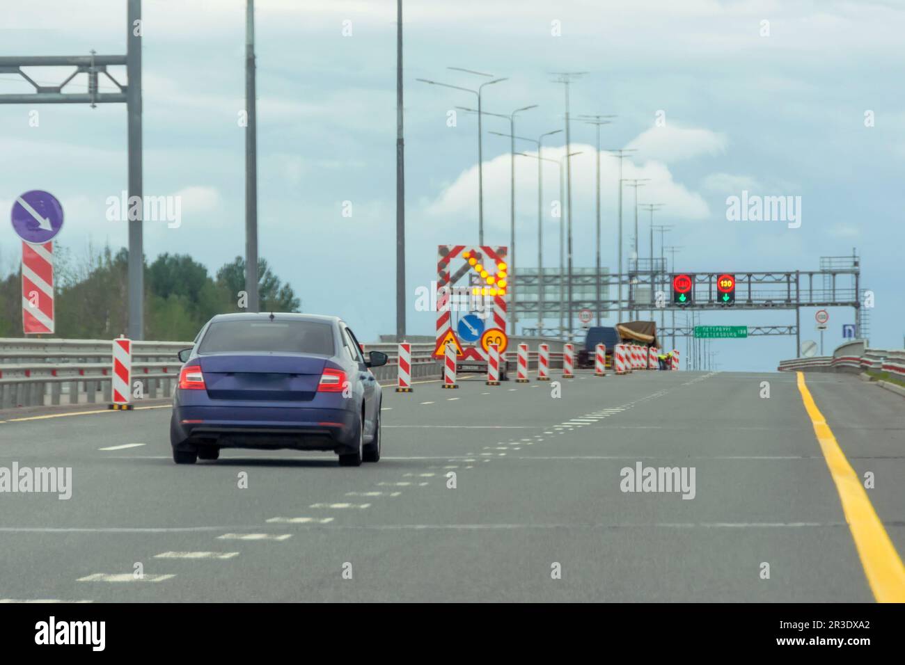 Roadworks, large bright mobile sign with stripes, detour direction. The ...