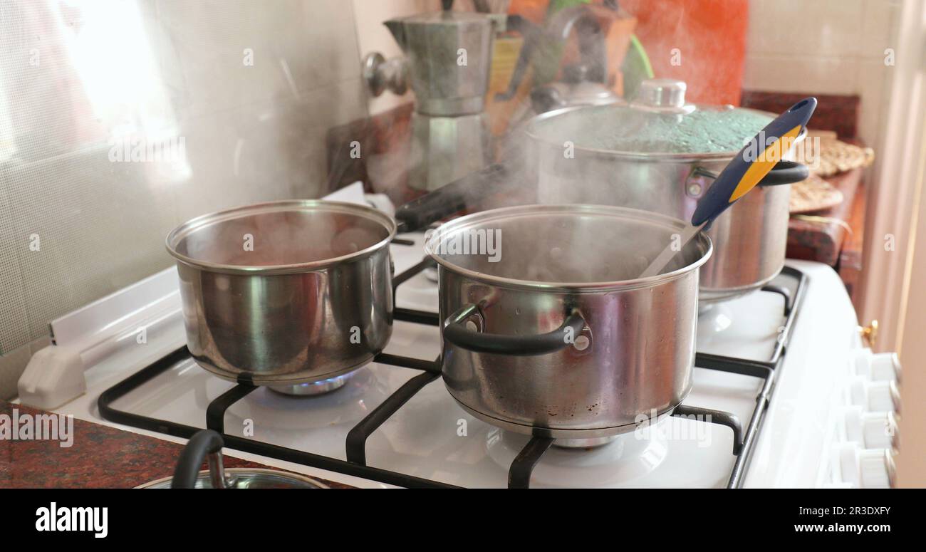 Cooking food, steam coming out from pans and pots Stock Photo - Alamy