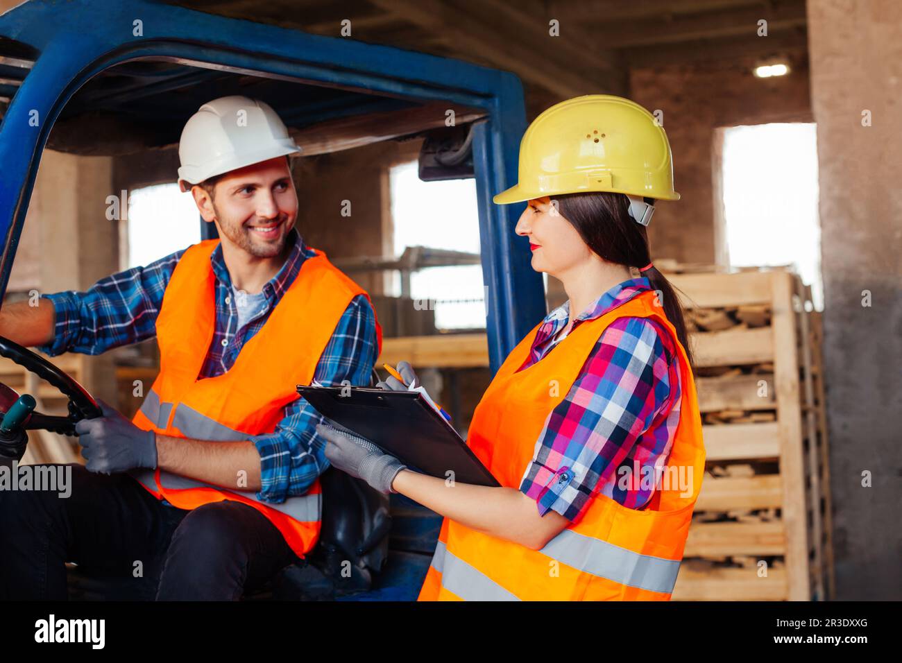 Young professional factory workers discussing working issues Stock ...