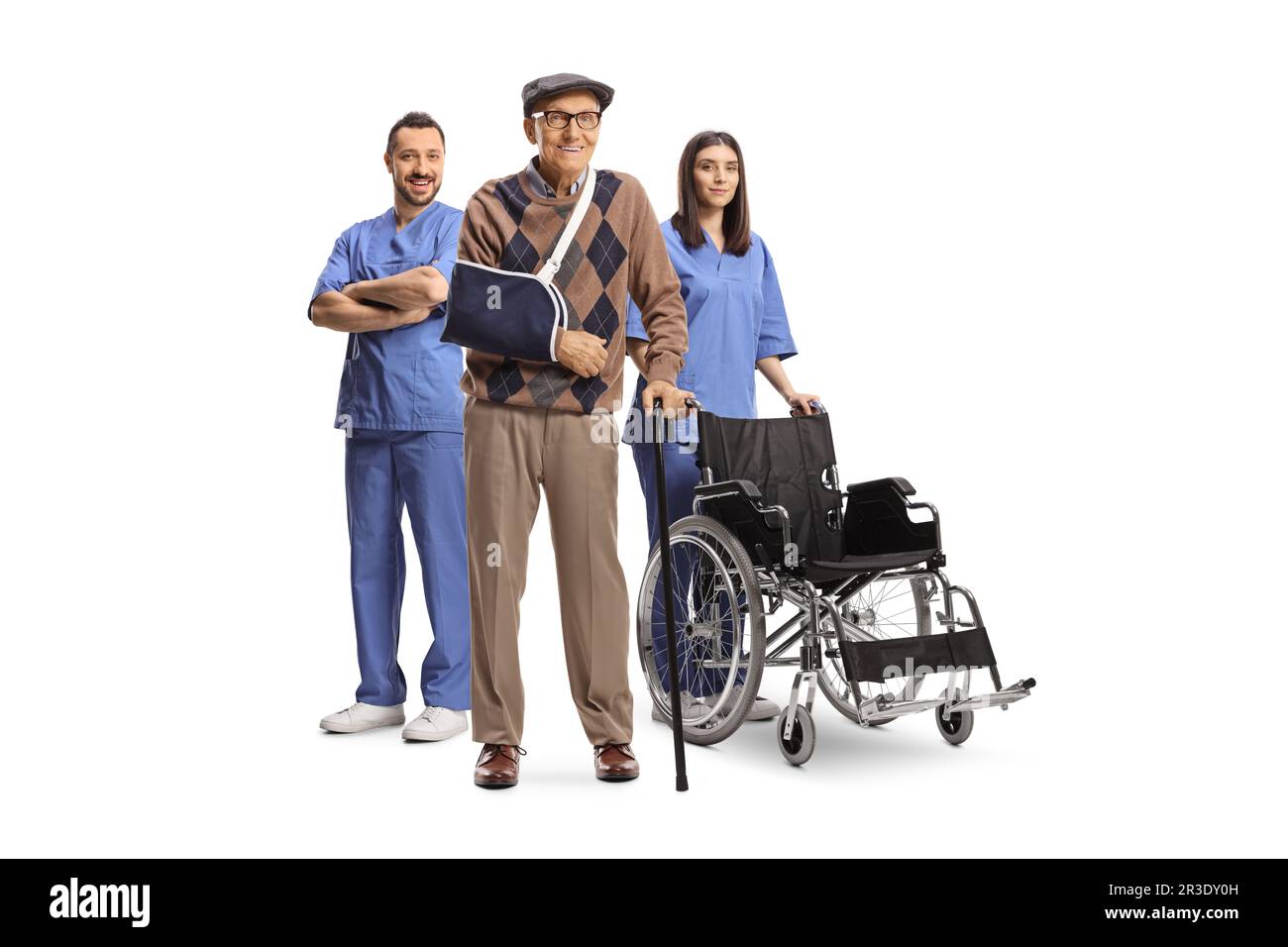 Male and female nurse with a wheelchair standing behind an elderly ...