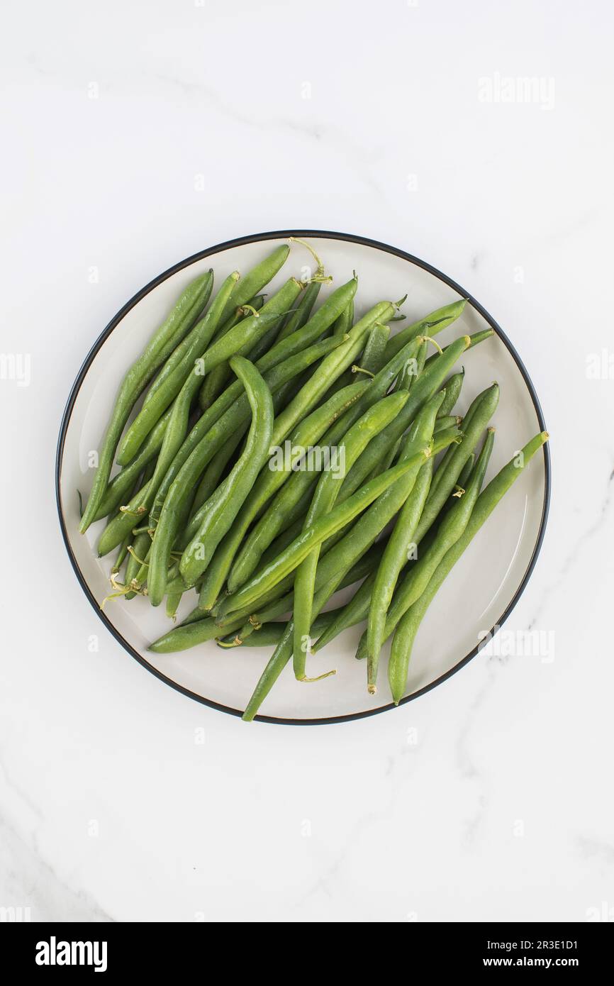 Green beans are raw in a plate. Healthy eating Stock Photo - Alamy