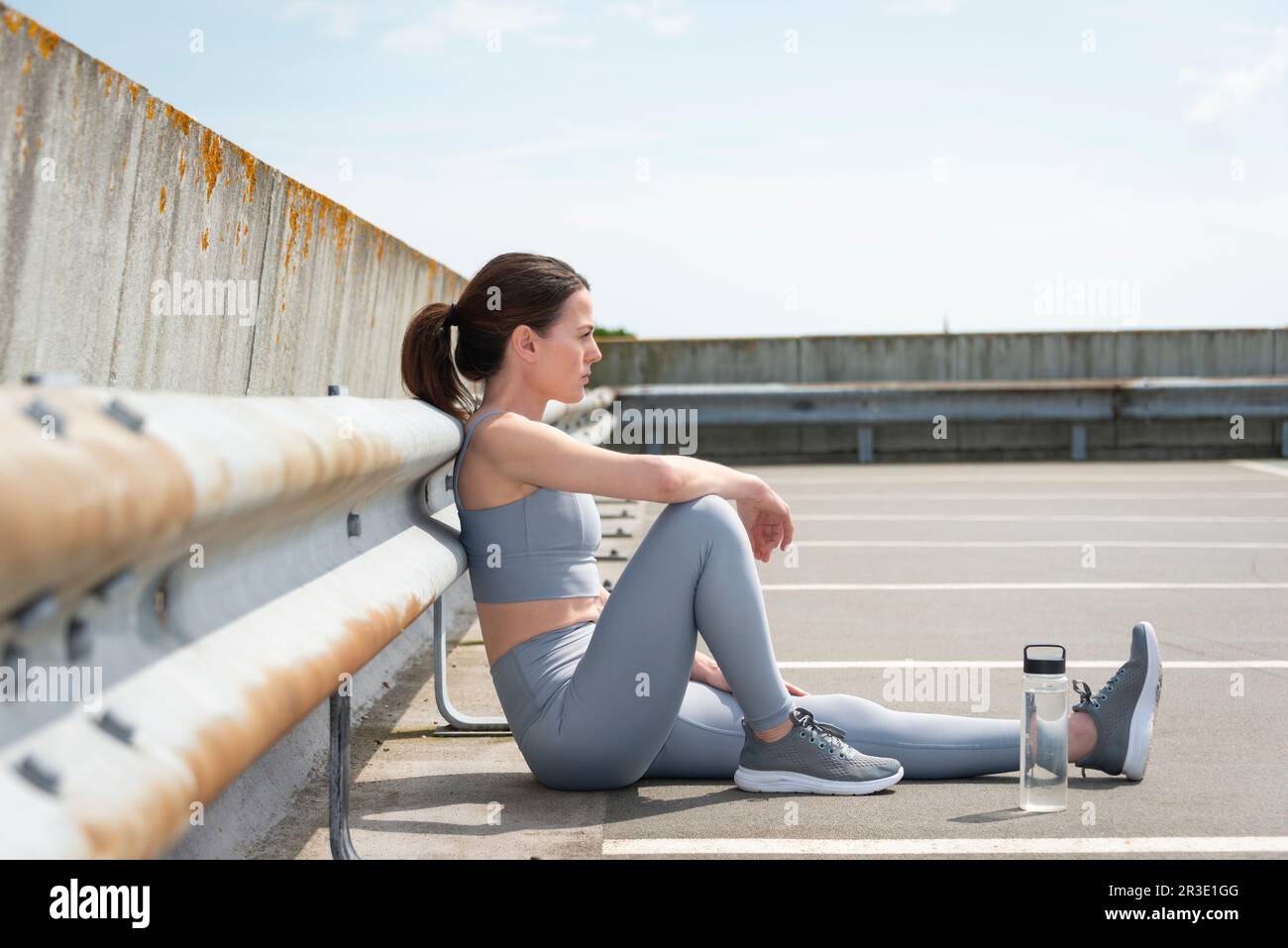 sporty female runner sitting resting after exercise Stock Photo - Alamy
