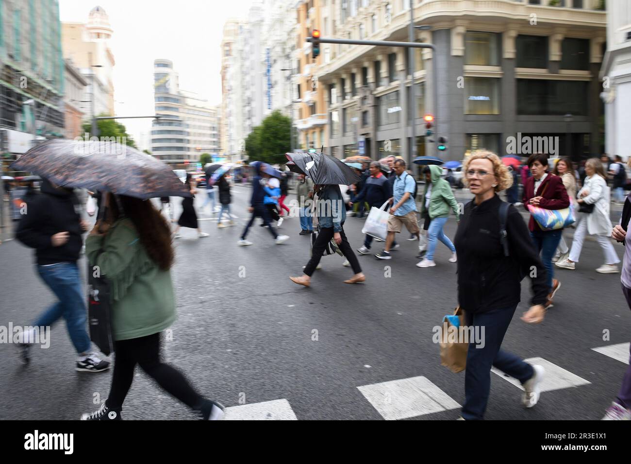 People walk in the rain on May 23, 2023 in Madrid, Spain. The State ...
