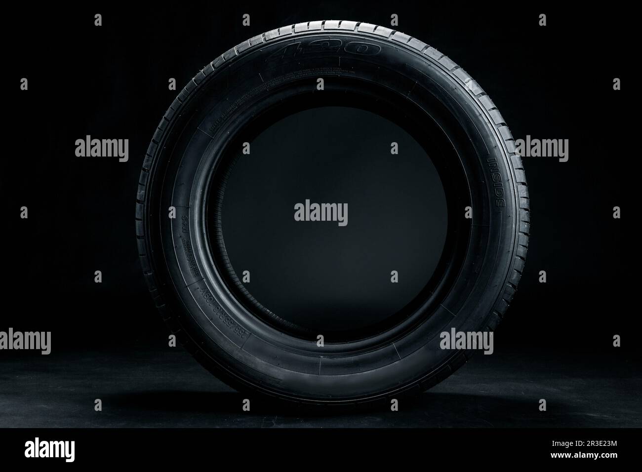 Brand new modern car tyre on a black background. Studio shot Stock ...