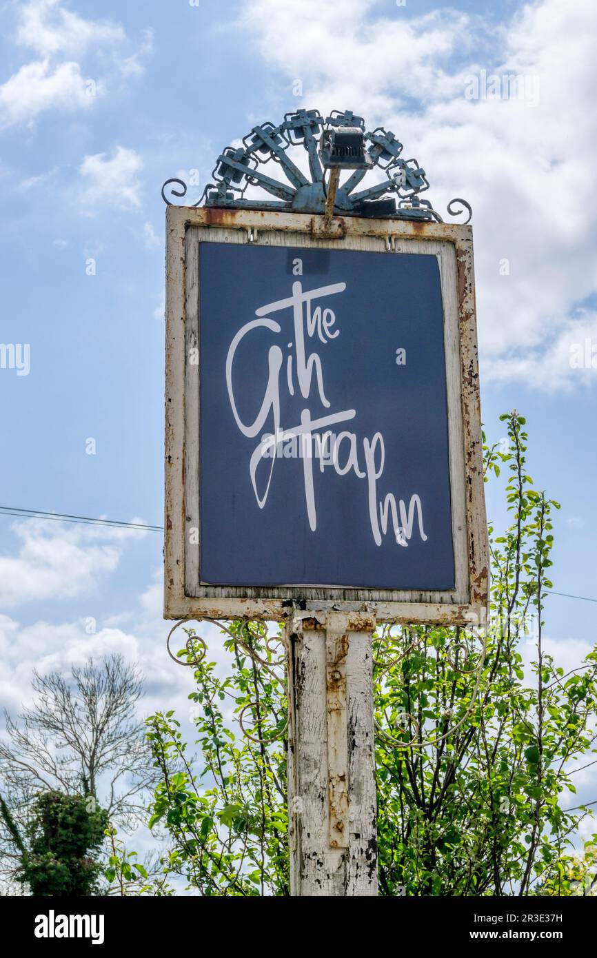 Sign for The Gin Trap Inn at Ringstead, Norfolk. Topped by a selection ...