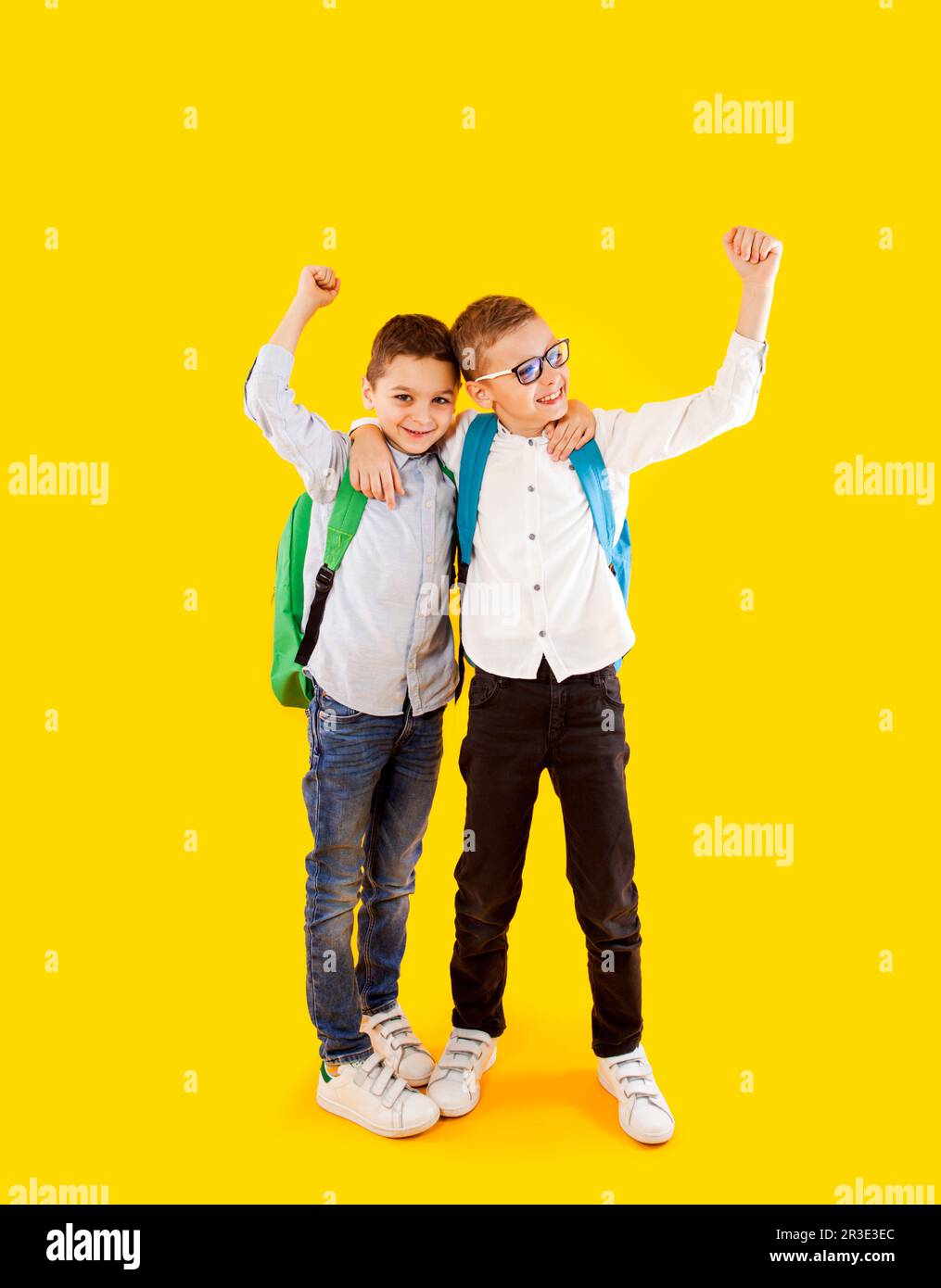 Two school friends stand in an embrace and smile Stock Photo - Alamy