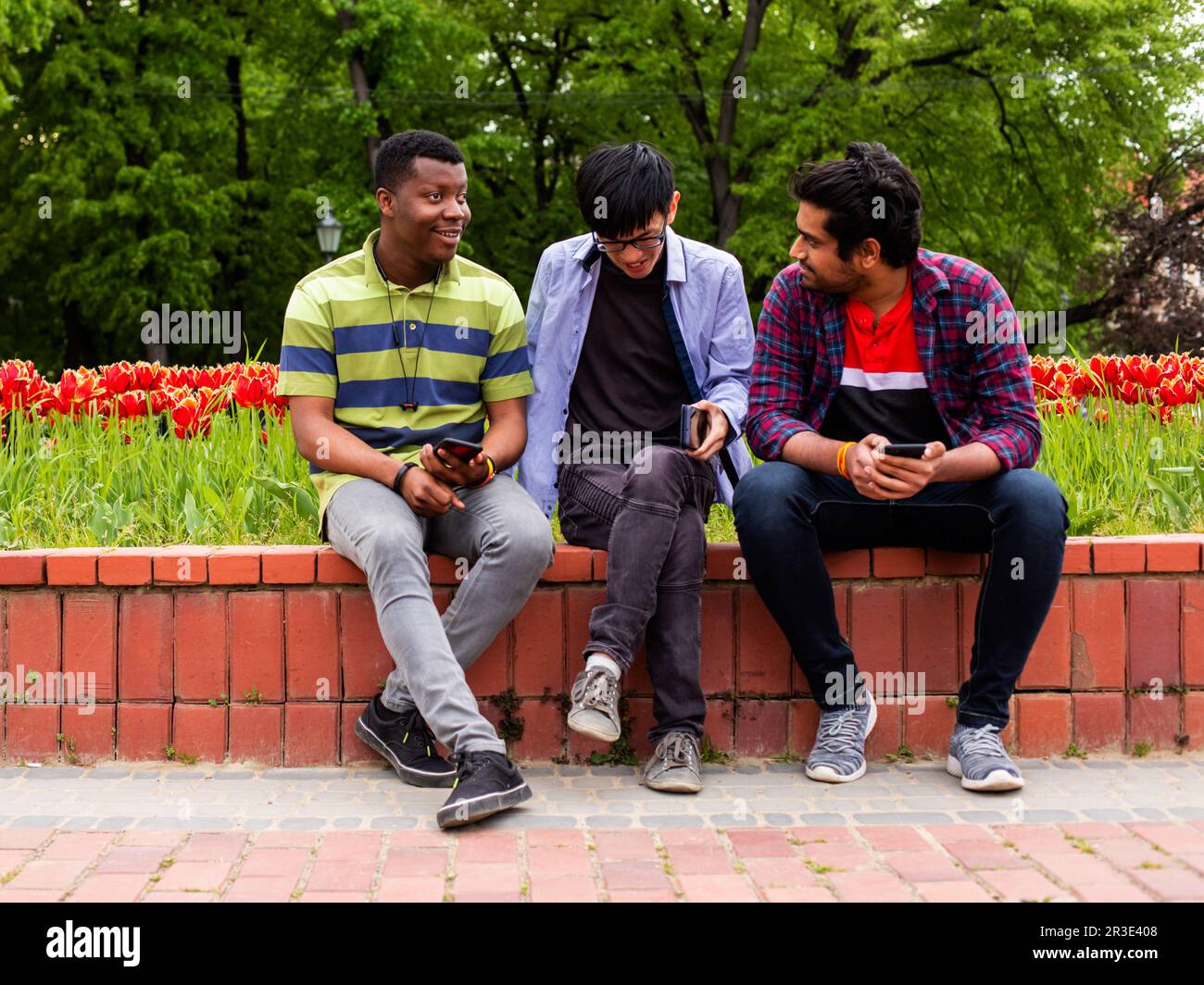 Three young men meeting during break between college lectures Stock ...