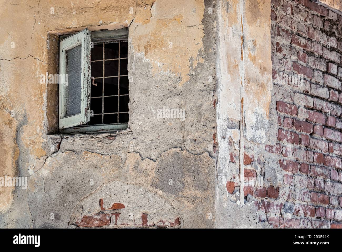Small wooden barred window. Vintage picture with the worn out old brick ...