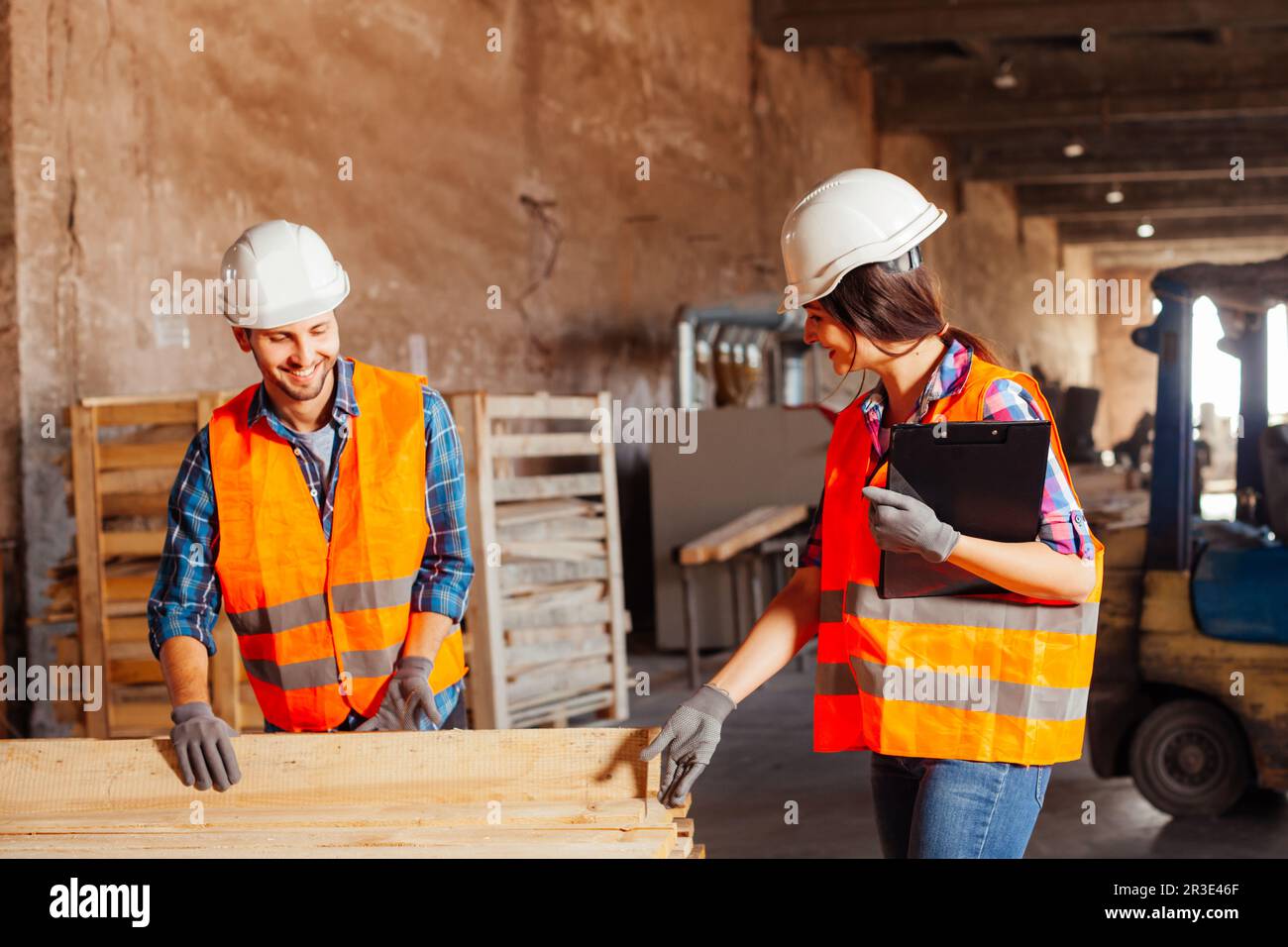 The woman inspector checks the work of a man in a warehouse Stock Photo ...