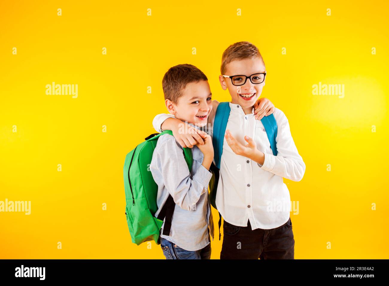 Two school friends stand in an embrace and smile Stock Photo - Alamy