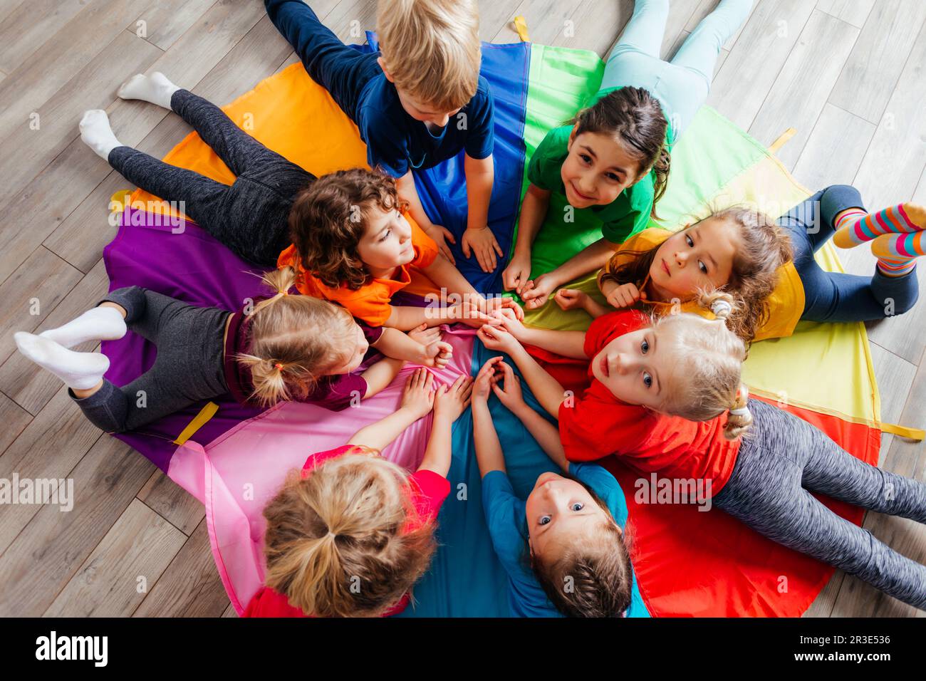 Happy kids laying on a floor in circle Stock Photo - Alamy