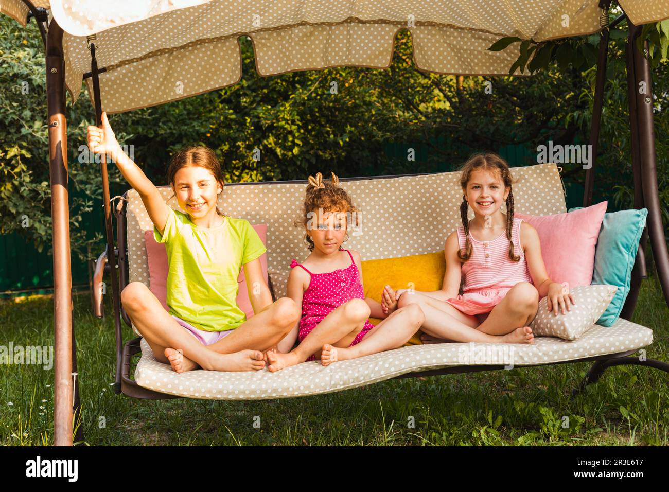 Three lovely sisters on soft garden swing Stock Photo - Alamy