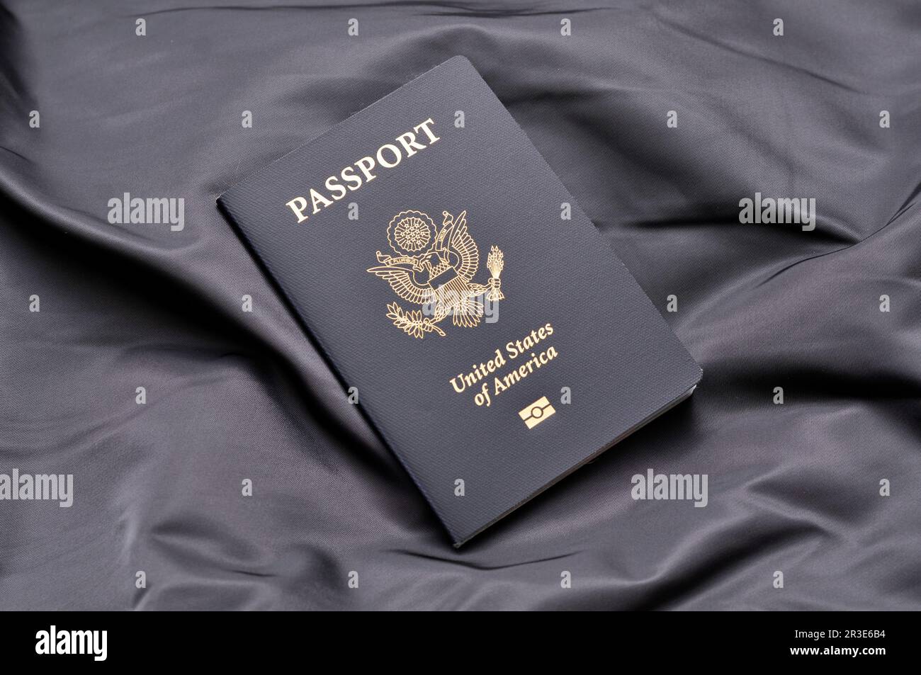 US passports on a dark blue fabric background. US document Stock Photo ...