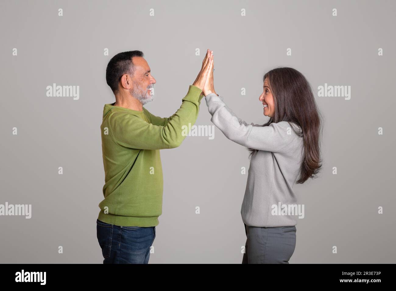 Happy caucasian aged husband and wife celebrating victory, give high ...