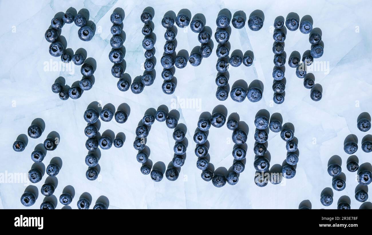 Inscription SUPER FOOD made of Fresh blueberries. Blueberry antioxidant ...