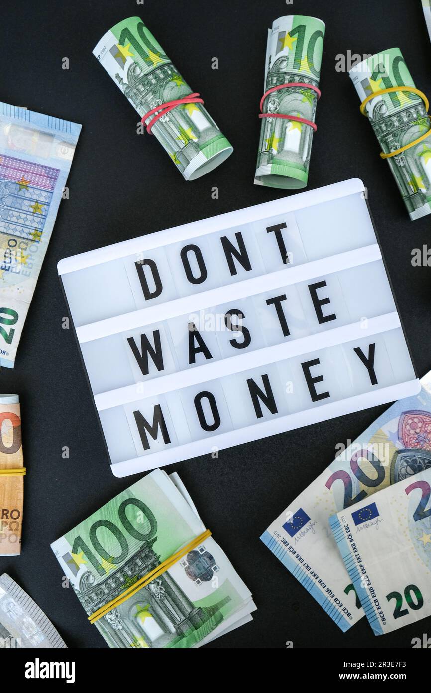 Lightbox board with word DONT WASTE MONEY in black letters around euro ...
