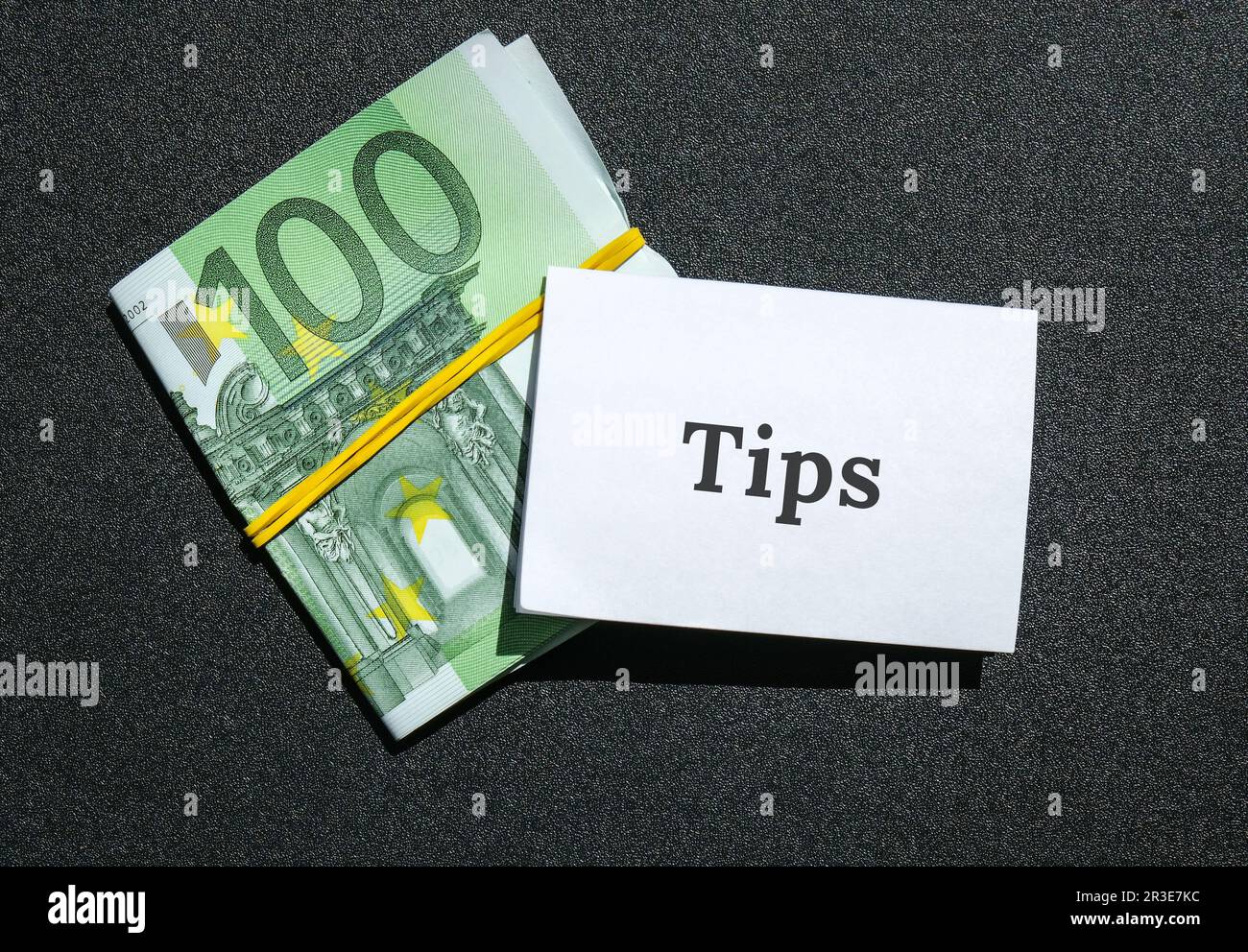Euro bills, savings ins, money. Paper note written word TIPS. Business ...
