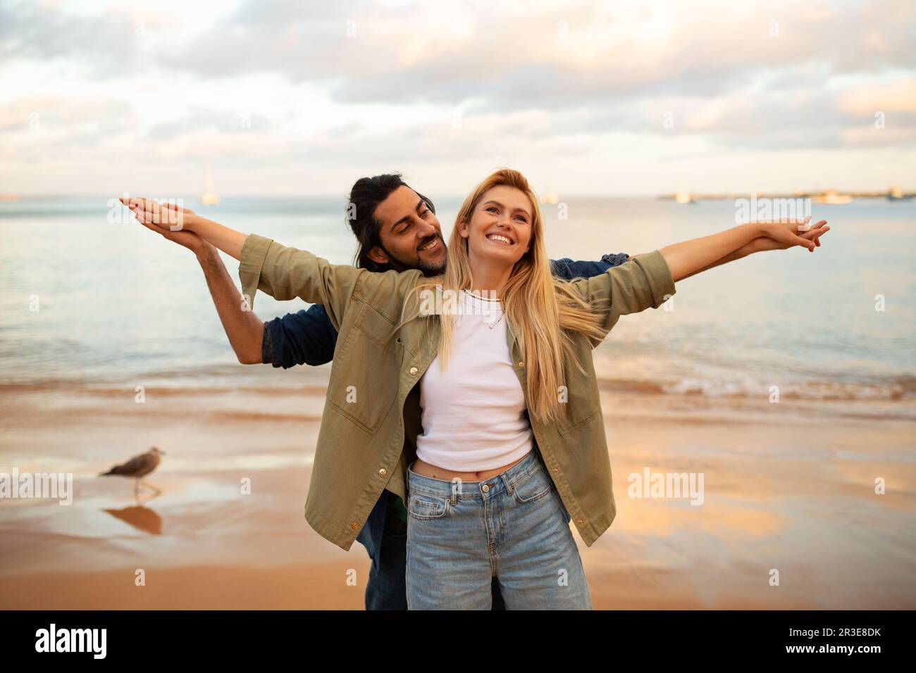 Happy Young Couple Having Romantic Moments On Beach Near Ocean Stock ...
