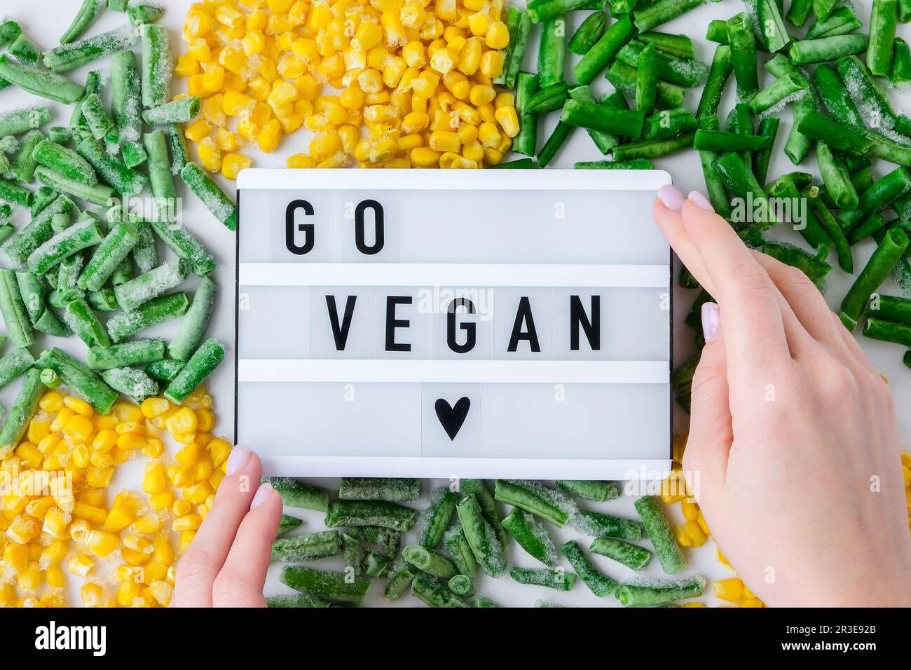 Lightbox with text GO VEGAN frozen vegetables food of yellow corn ...