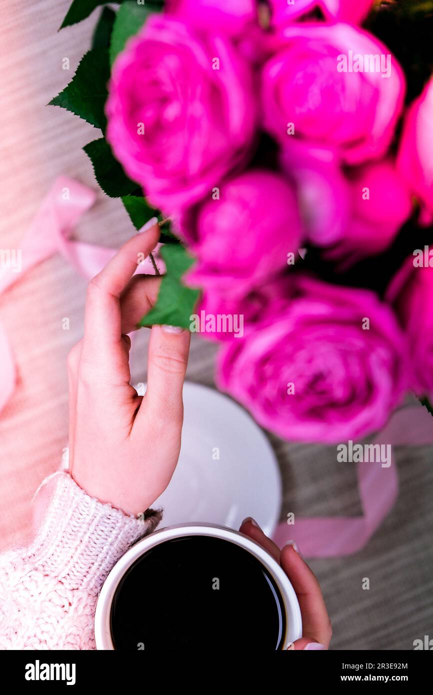 Cup of coffee and pink roses. Holiday concept, bouquet of roses for a ...