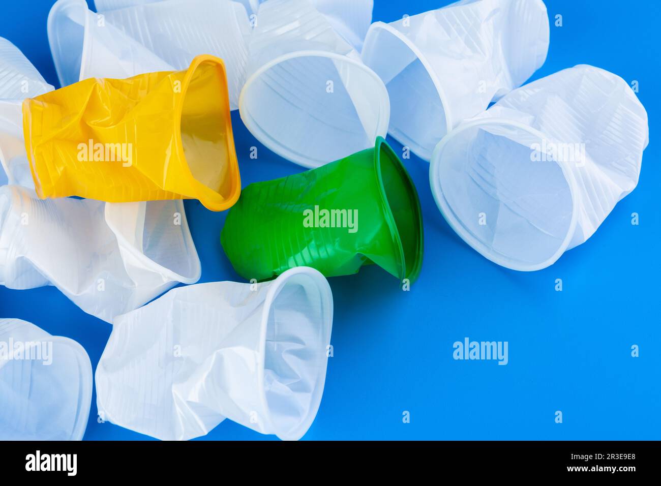 Disposable colored plastic cups garbage. Garbage and pollution concept ...