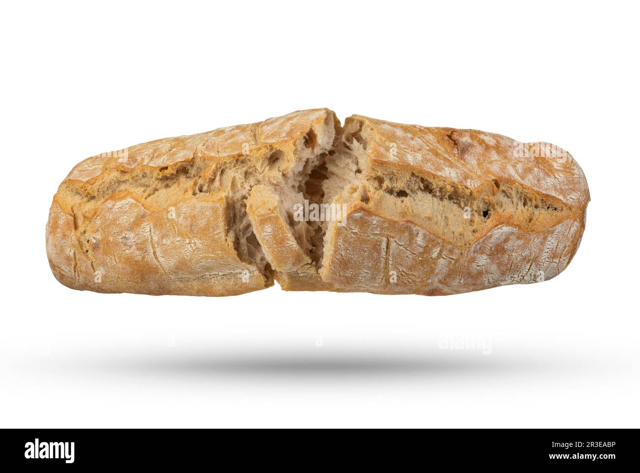 A loaf of Italian fresh ciabatta bread is broken into 2 parts on a ...