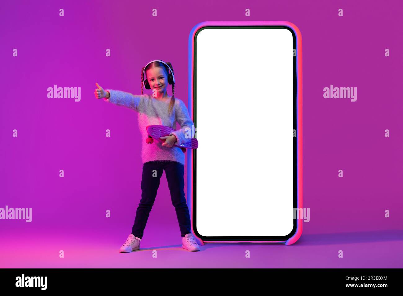 Sweet preteen girl with wireless headphones and skateboard next phone ...
