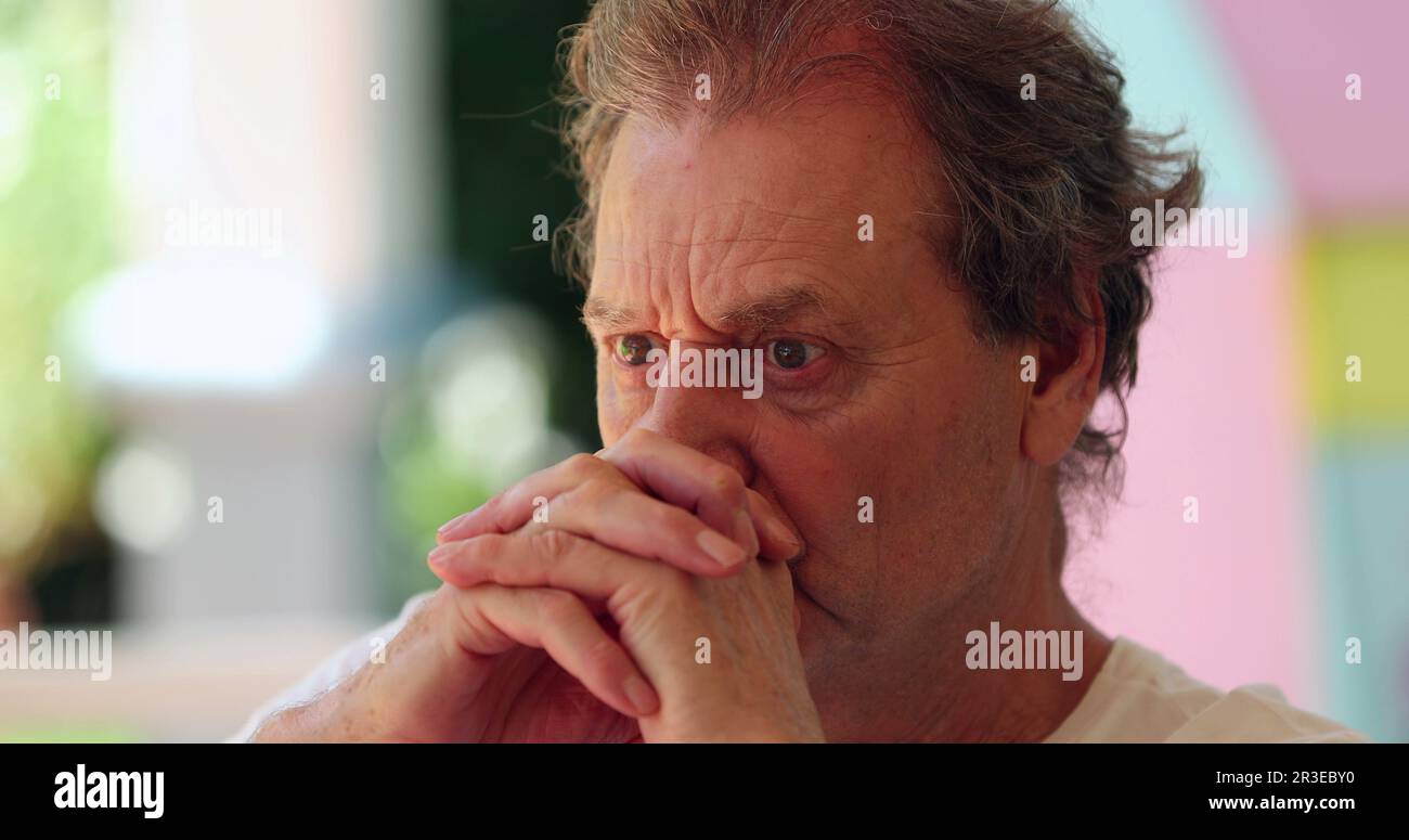 Pensive older man thinking deeply. Candid thoughtful senior person ...