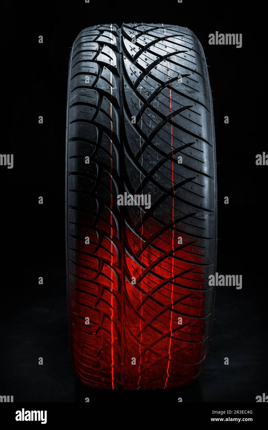 Brand new modern car tyre on a black background. Studio shot Stock ...