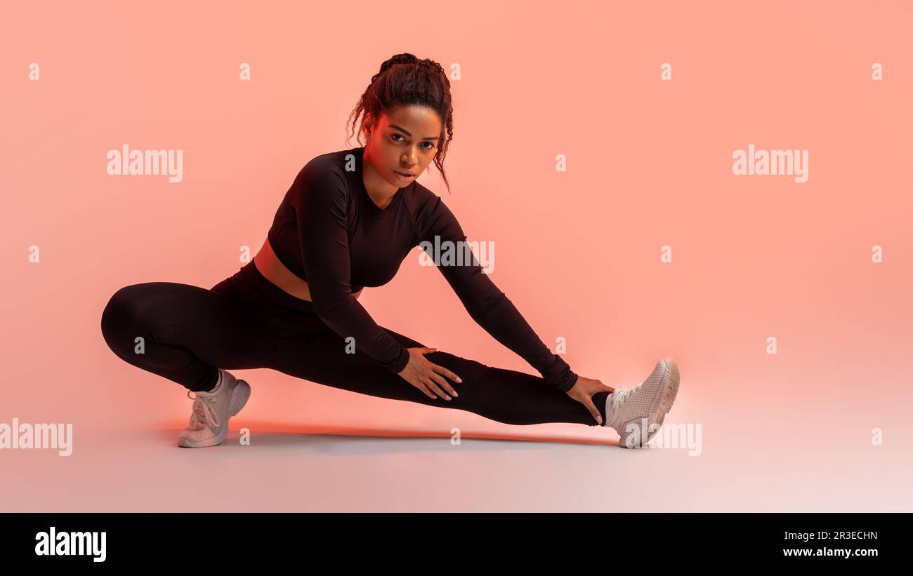 Studio perfection. Fit black lady mastering her exercise routine ...