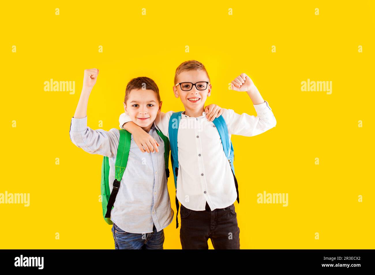 Two school friends stand in an embrace and smile Stock Photo - Alamy