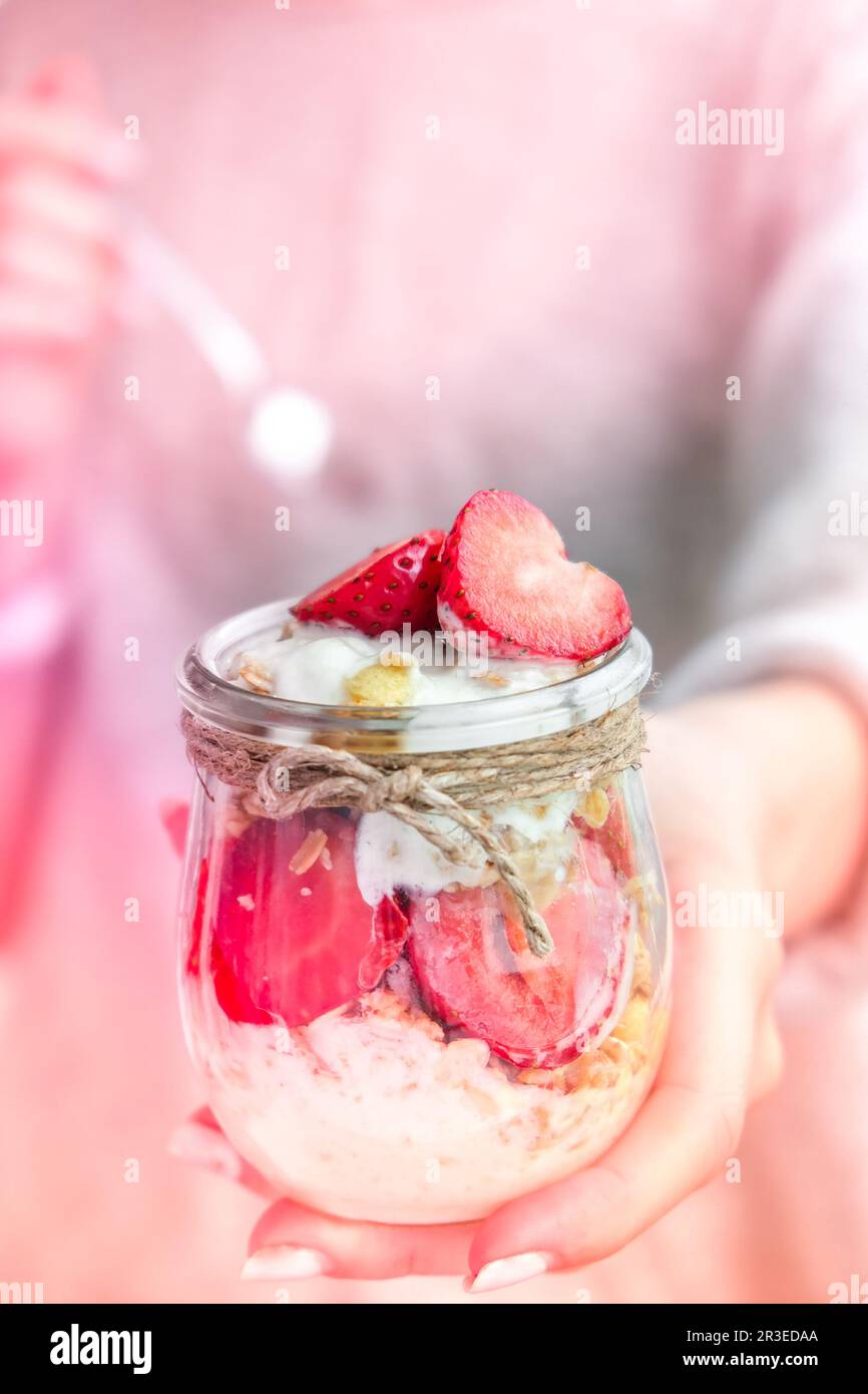 Female hands woman eating Healthy breakfast. Oatmeal Granola with greek ...