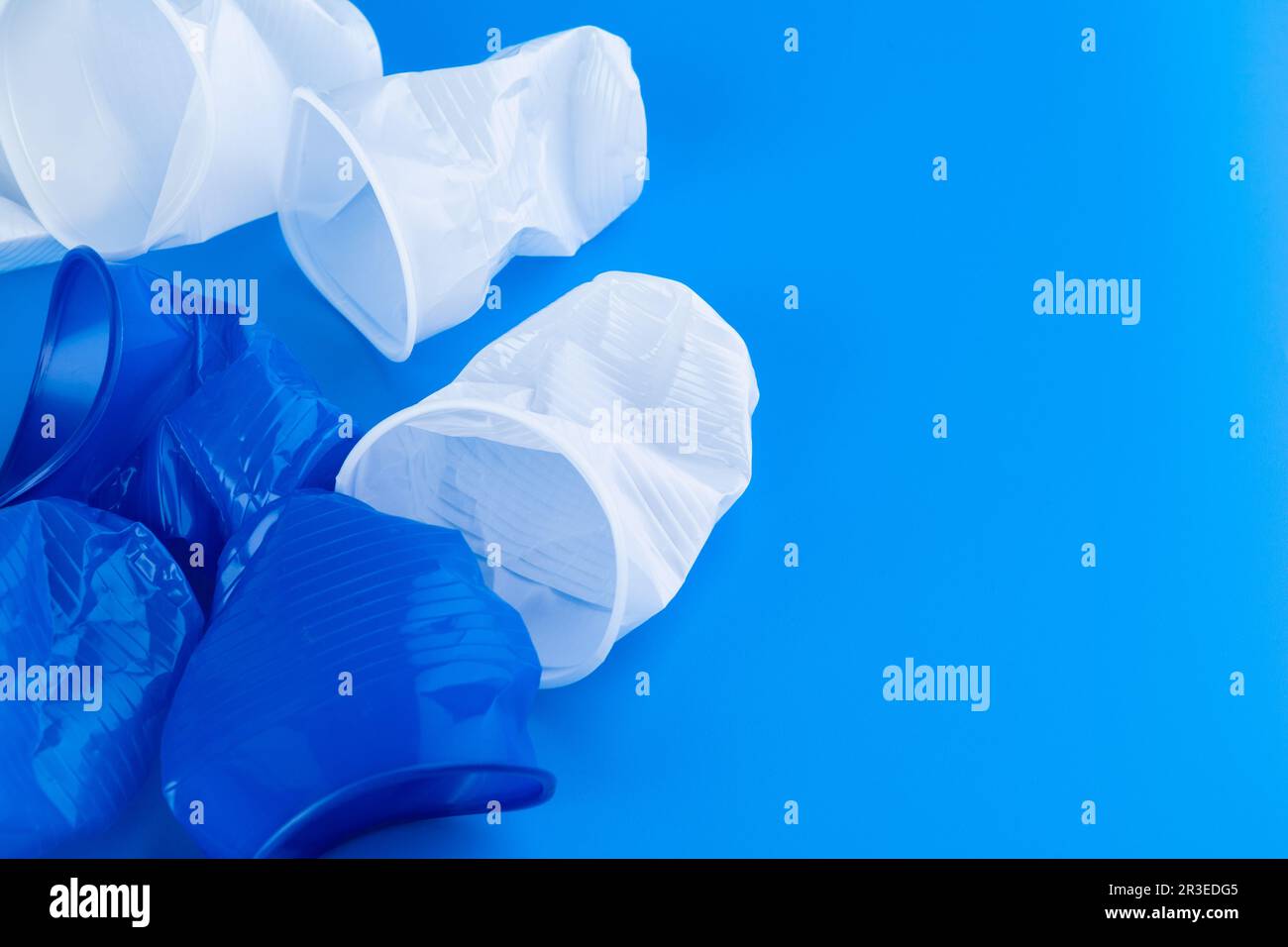 Disposable colored plastic cups garbage. Garbage and pollution concept ...