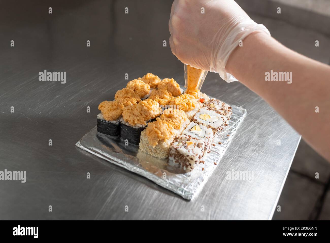 Putting cheese filling, on the cap of the roll, out of the bag Stock ...