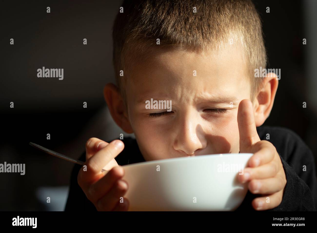 Little boy eat soup Stock Photo - Alamy