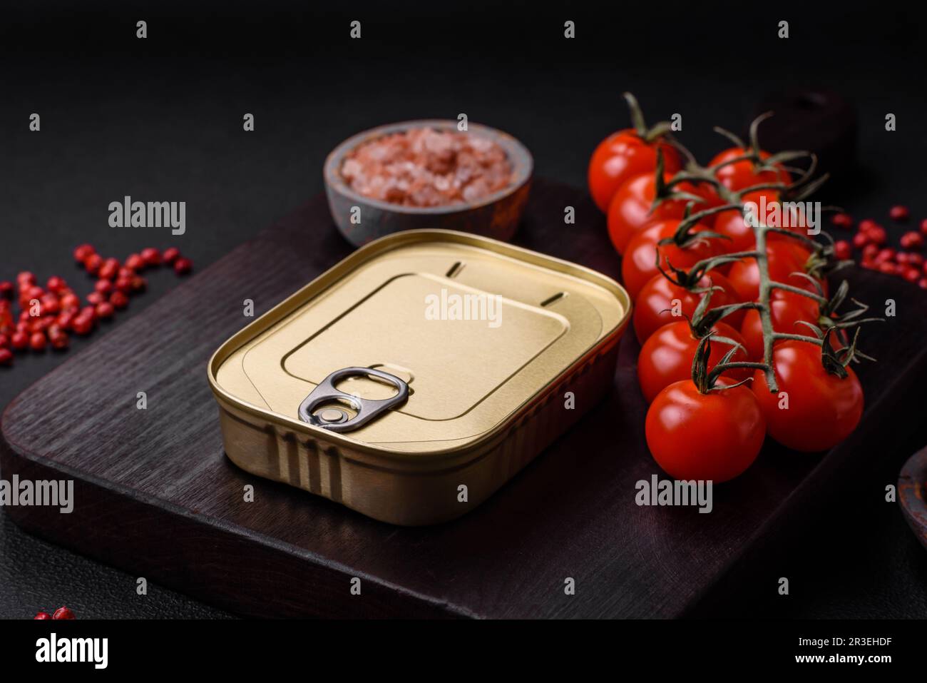 Tin or aluminum rectangular can of canned food with a key on a dark ...