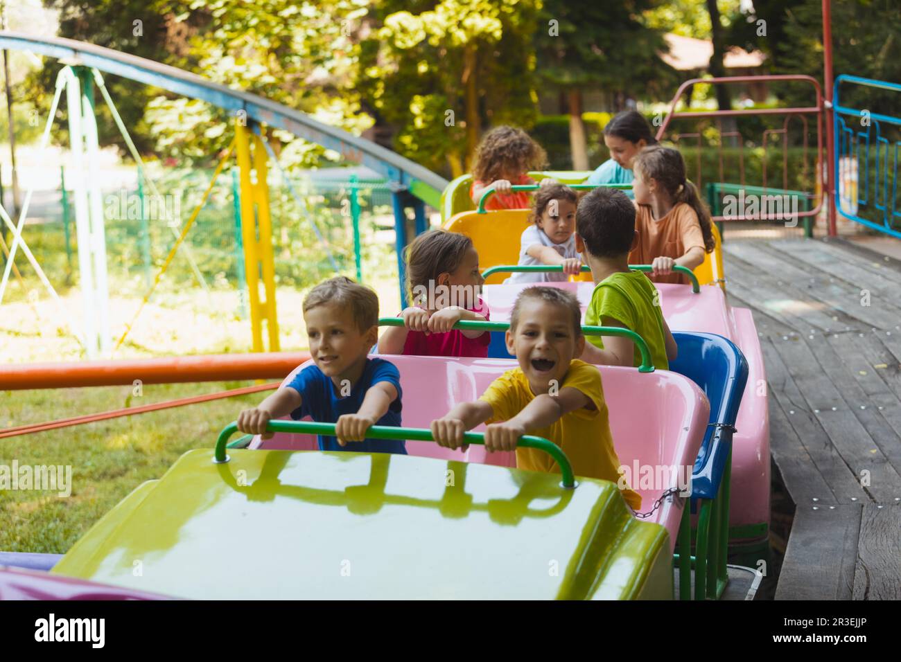 Kids on colorful amusement park hi-res stock photography and images - Alamy