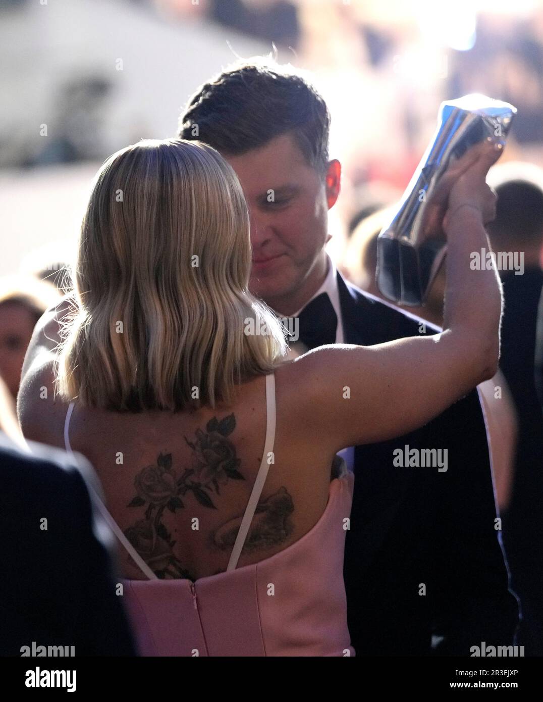 Scarlett Johansson, left, and Colin Jost embrace upon departing the ...