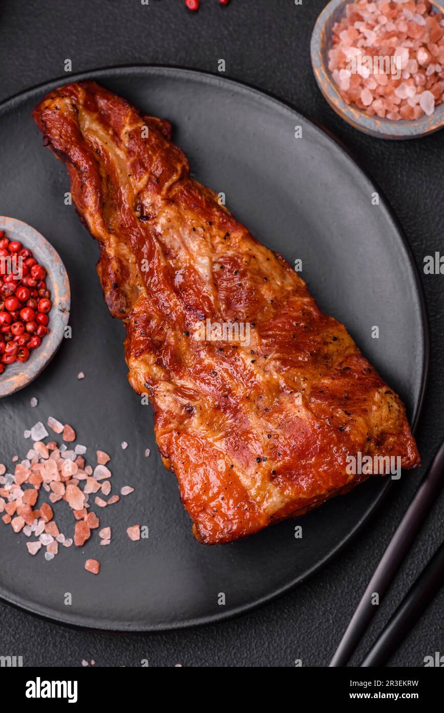 Delicious grilled or smoked pork ribs with salt, spices and herbs on ...