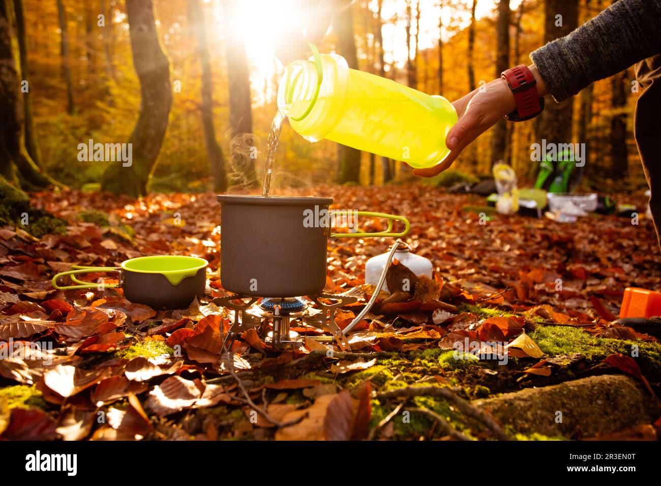 Woman flow water from collapsible bottle to a portable pan Stock Photo ...