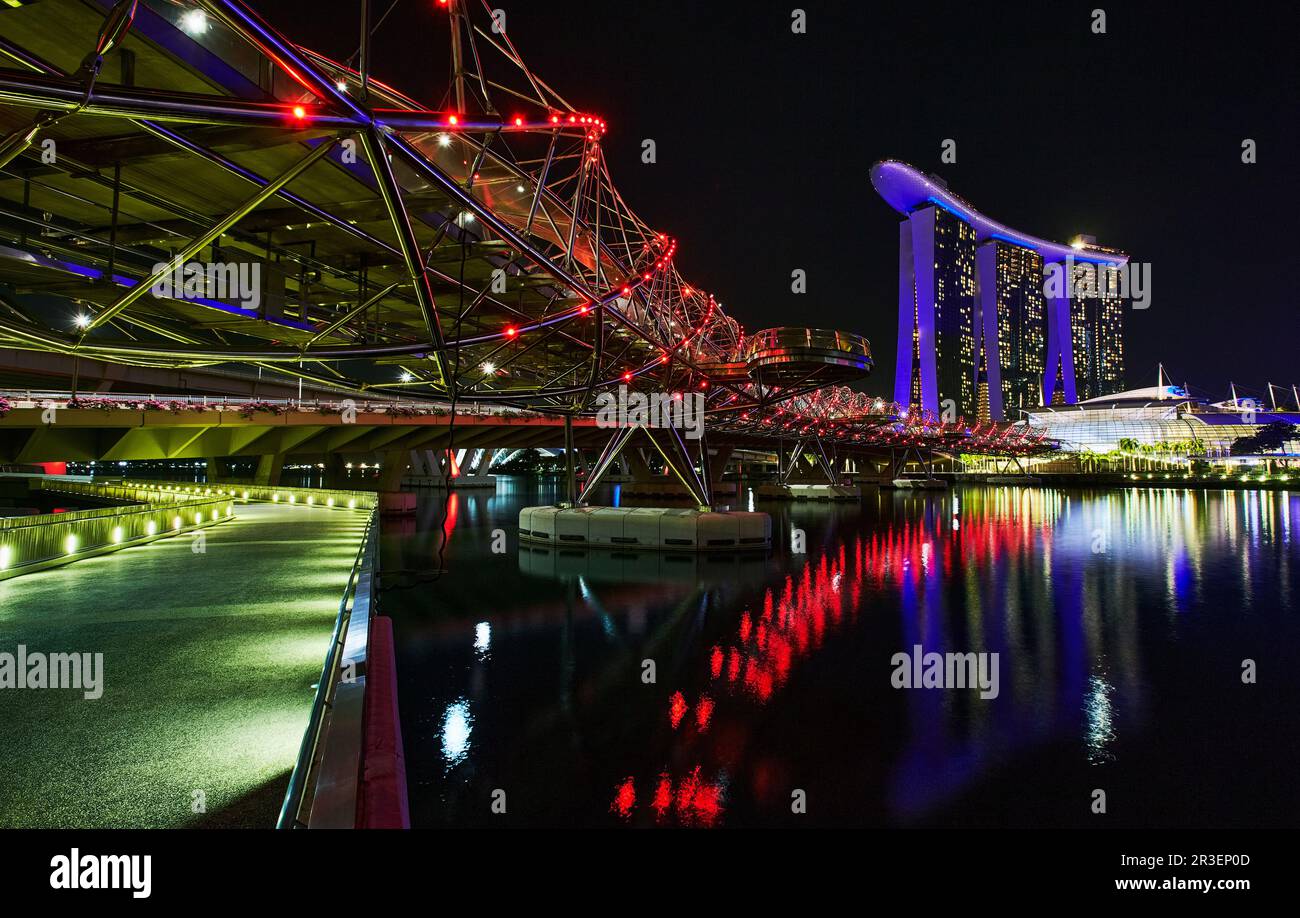 View of the hotel «Marina Bay Sands», Helix Bridge and in the evening ...