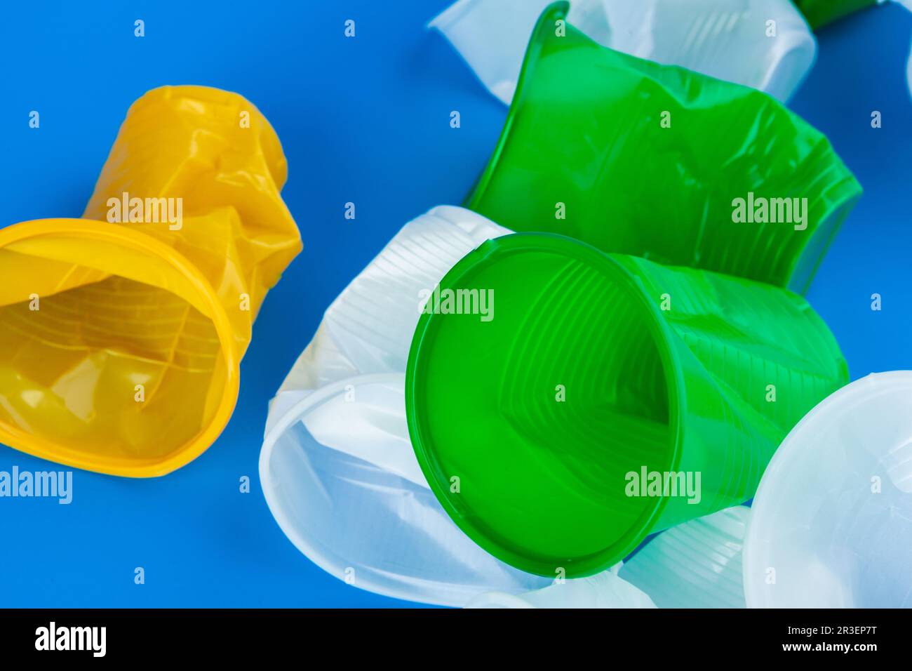 Crumpled empty single-use plastic cups, studio shot. Plastic pollution ...