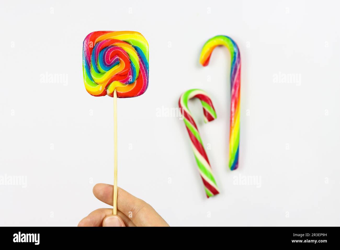 Multicolored square lollipop, sweet candy in rainbow colors after ...