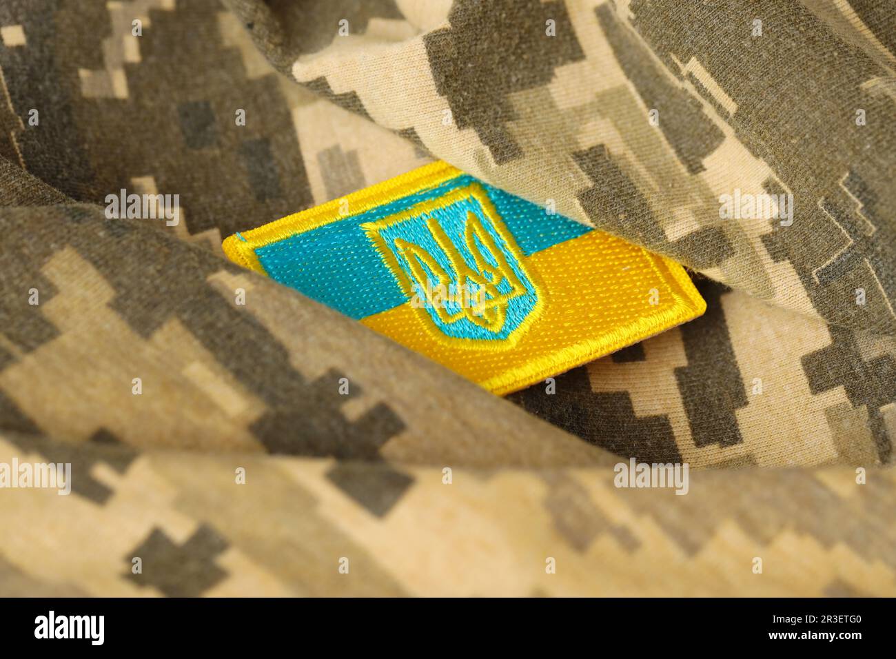 Pixeled digital military camouflage fabric with ukrainian flag and coat ...