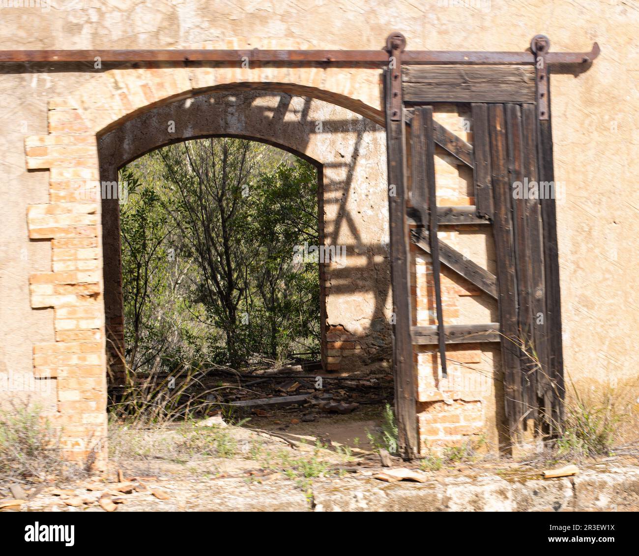 Detail of a wooden sliding door of a railway warehouse in ruins. Door ...
