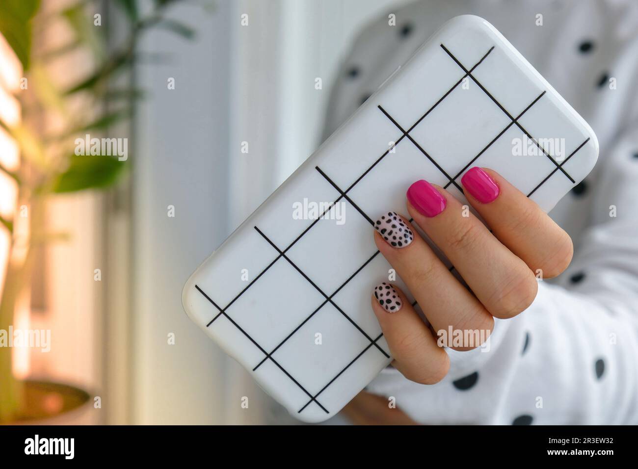 Manicured female hands with stylish pink nails holding mobile phone ...