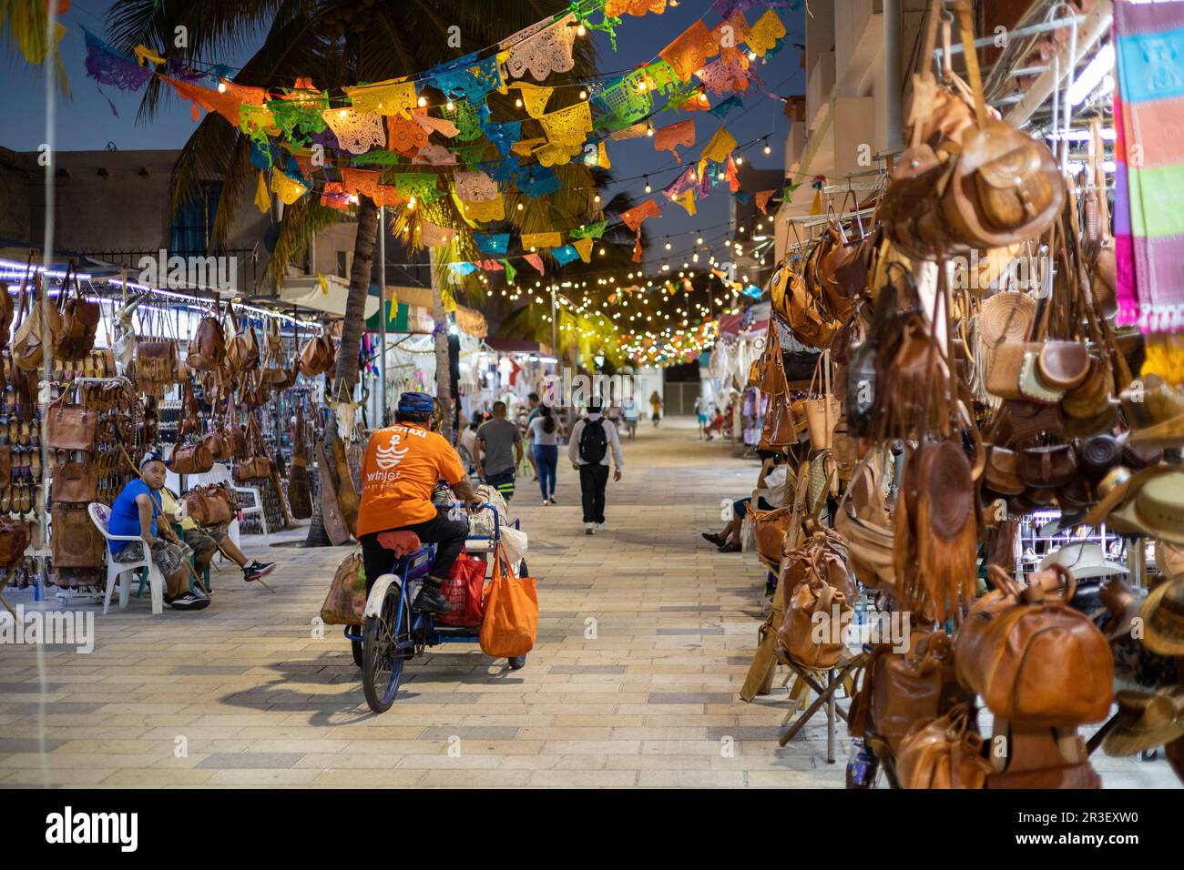 PLAYA DEL CARMEN, Mexico - Feb 2023: Illuminated storefronts lining up ...