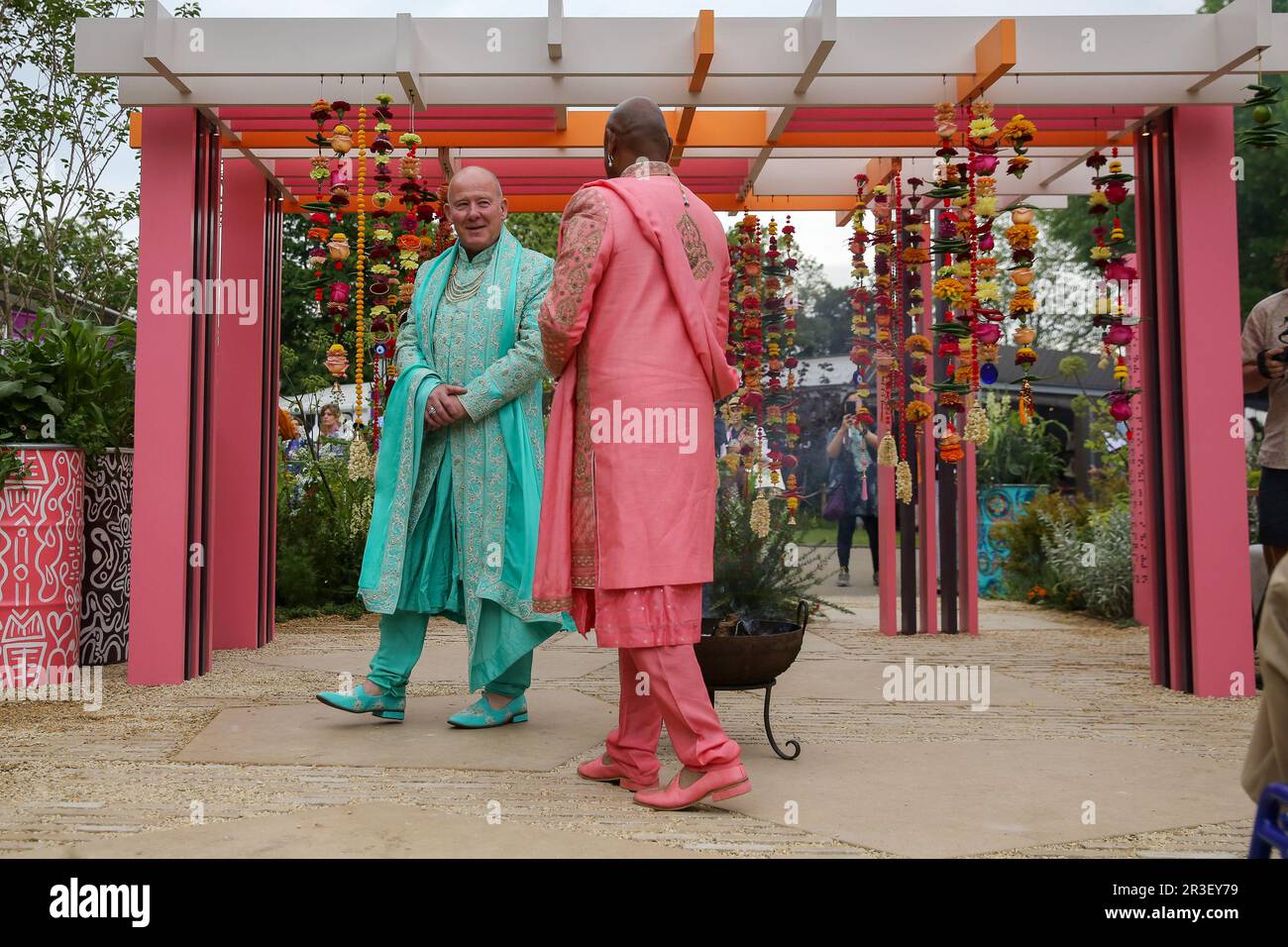 Manoj Malde and Clive Gillmor walk round the fire as part of the Indian ...