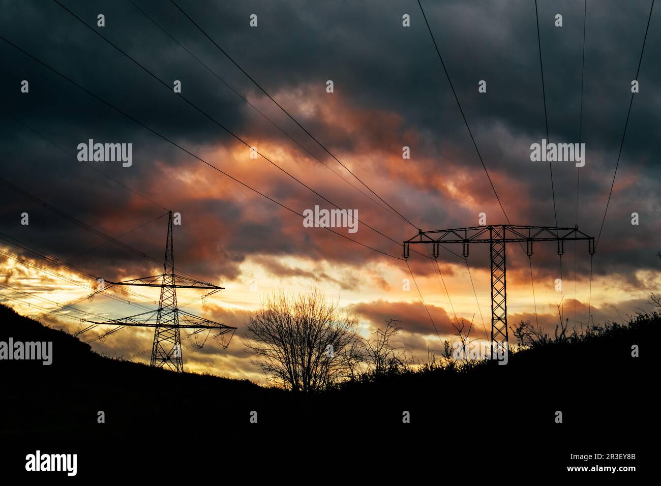 High voltage power line overhead line sunset Stock Photo - Alamy